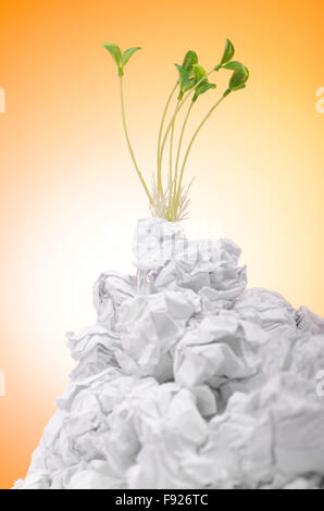 Green seedlings growing out of paper Stock Photo - Alamy