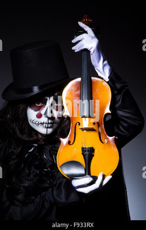 Monster playing violin in dark room Stock Photo - Alamy