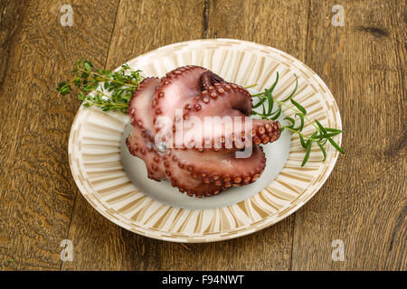 Boiled octopus with herb on the wood background Stock Photo - Alamy