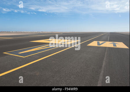 Directional sign markings on the tarmac of runway at a commercial ...
