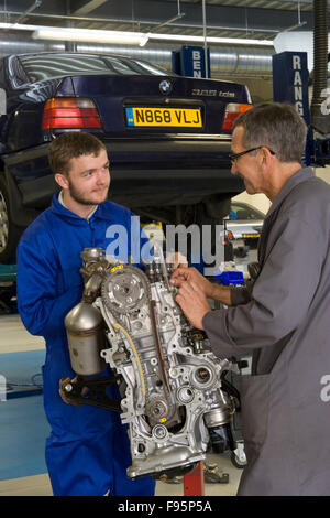 Apprentice car-mechanic & instructor Stock Photo - Alamy