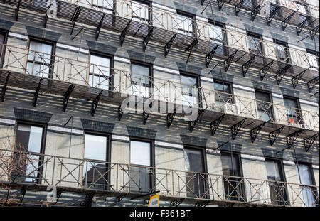Fire escapes on tenement apartment buildings in Harlem neighborhood ...
