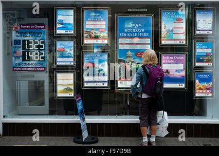 Posters in a vacation travel agents window display Stock Photo - Alamy