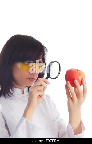 Female scientist looking at apple through magnifying lens Stock Photo ...