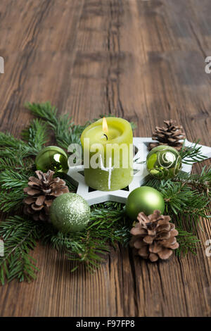 Advent wreath with four burning white candles and Christmas decoration ...