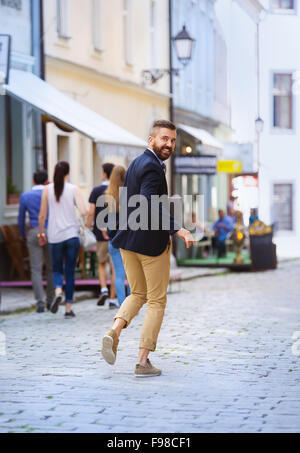 Hipster businessman running on the street in the city Stock Photo - Alamy