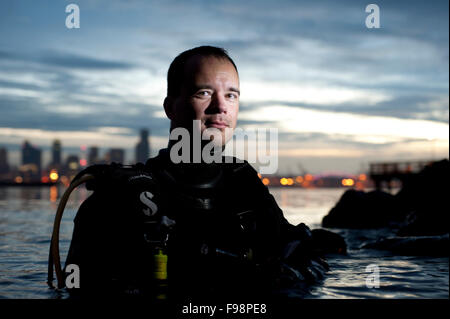 Scuba diver portrait with city background Stock Photo - Alamy
