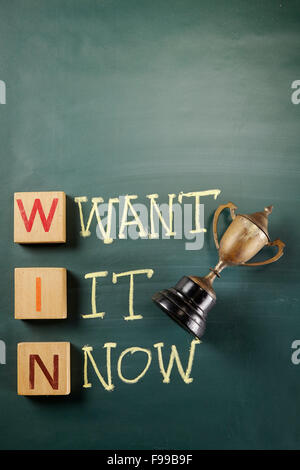 Hand writing WIN- Want it now written with chalk on blackboard Stock ...