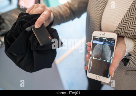 Nancy Greco, employee of IBM's research division, shows a smartphone ...