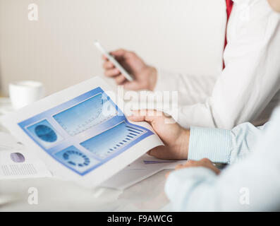Business people reading graphs and charts Stock Photo - Alamy