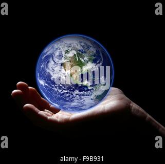 Hand holding the earth, computer artwork Stock Photo - Alamy