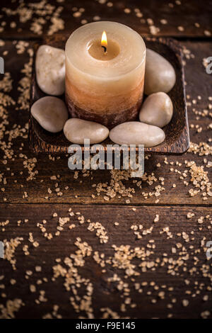 Spa treatment composition on wooden table, diffuser candles and pink ...
