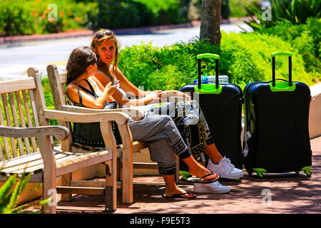 Two Girls at Bus Stop Stock Photo - Alamy