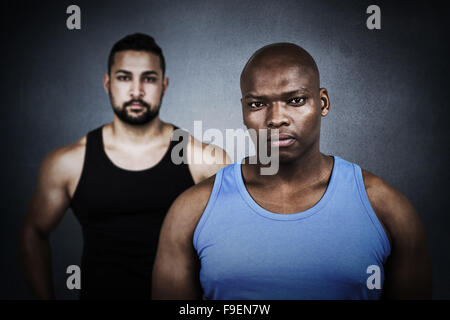 Composite image of strong friends looking at camera Stock Photo - Alamy