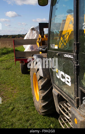 A JCB Telehandler being used to move concrete barrier blocks into place ...