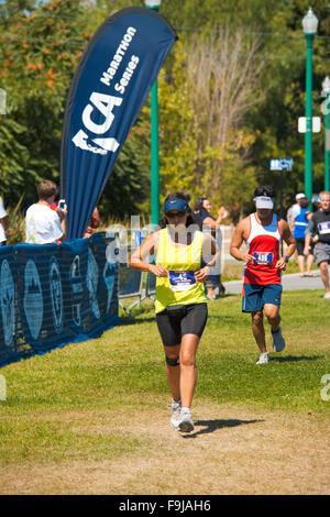asian male runner crossing finish line Stock Photo - Alamy