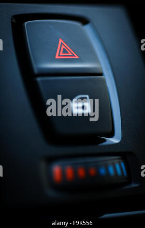 Detail of a warning button in a car Stock Photo - Alamy
