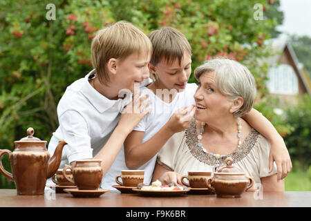 Family drinking tea in garden Stock Photo - Alamy