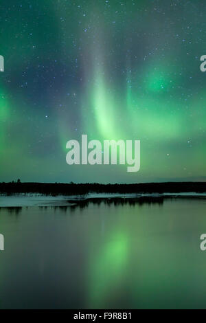 Beautiful northern lights over lake Stock Photo - Alamy