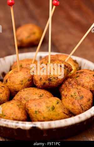 spanish fritters served on a wooden table with a cup of hot chocolate ...