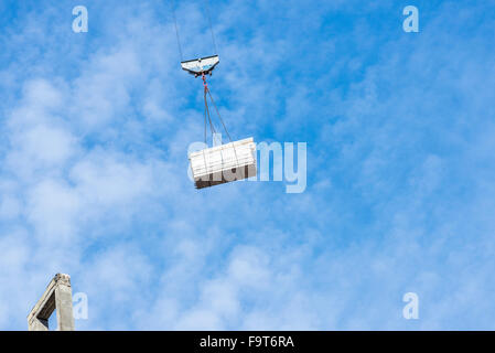 Crane lifting a lot of boards for building a skyscraper in Barcelona ...