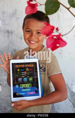 7 year old boy using tablet computer Stock Photo - Alamy