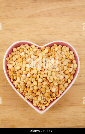 yellow daal in the heart shape container Stock Photo - Alamy