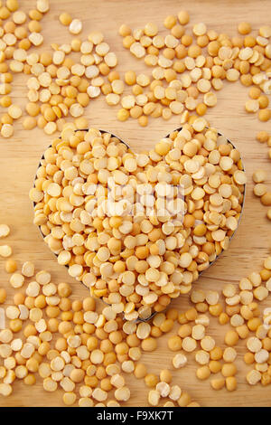 yellow daal in the heart shape container Stock Photo - Alamy