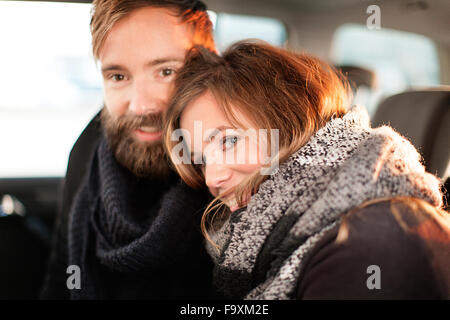 Happy couple cuddling in a car Stock Photo - Alamy