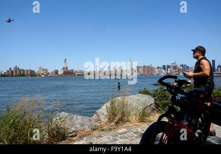 Man flying drone at a river Stock Photo - Alamy
