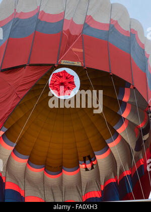 A hot air balloon deflating after landing in a field in Cheshire Stock ...