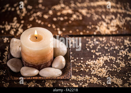 Beautiful composition with spa stones and candle on table on dark ...