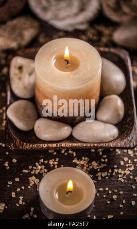 Spa relaxation setting with candle and stones Stock Photo - Alamy
