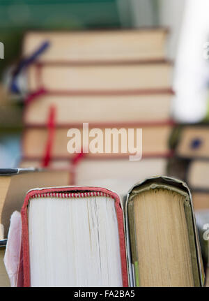 Row of aged retro books spine on shelf detail with selective focus ...