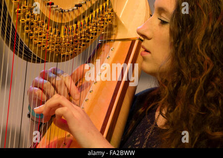 girl playing the harp on stage during a concert Stock Photo - Alamy
