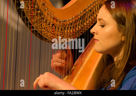 girl playing the harp on stage during a concert Stock Photo - Alamy