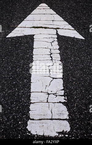 white arrow direction sign on grey concrete Stock Photo - Alamy