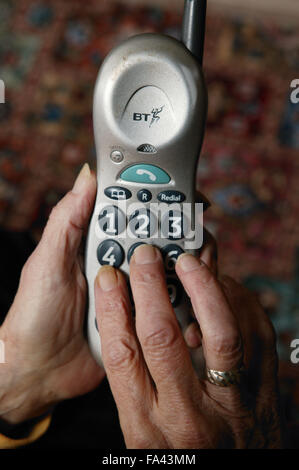 Visually impaired elderly woman dialling NHS 111 help line on big ...