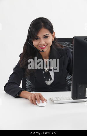 beatiful receptionist wearing head set talking Stock Photo - Alamy