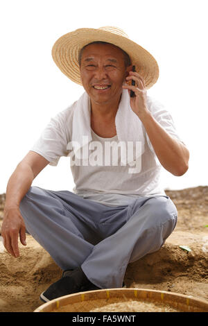 Farmers make a phone call Stock Photo - Alamy