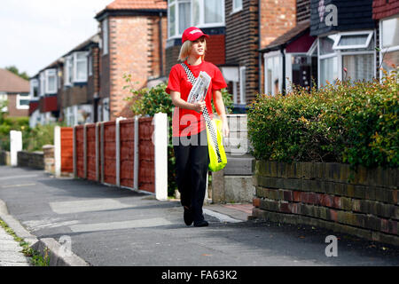 A papergirl on a newspaper round Stock Photo - Alamy