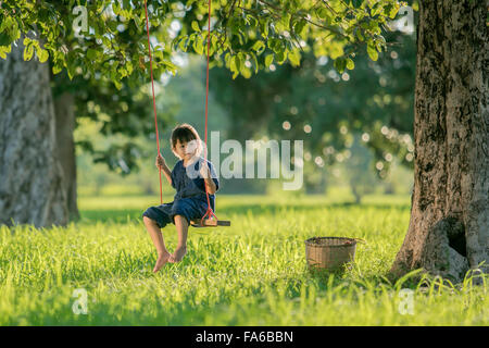 children girl swinging in a tree trunk in a pine forest Stock Photo - Alamy