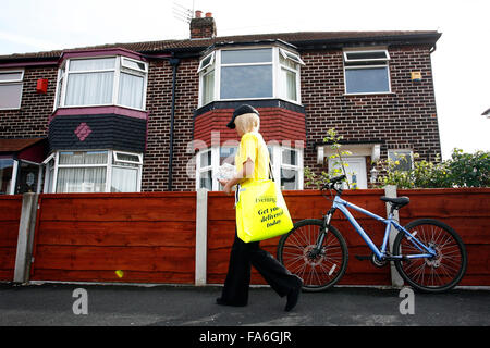 A papergirl on a newspaper round Stock Photo - Alamy