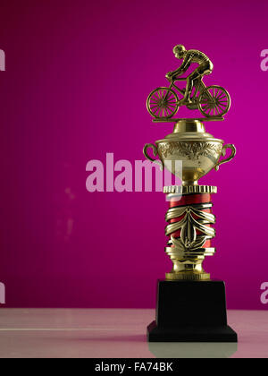 Trophy against the pink glass background Stock Photo - Alamy