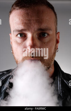 man blowing smoke Stock Photo - Alamy