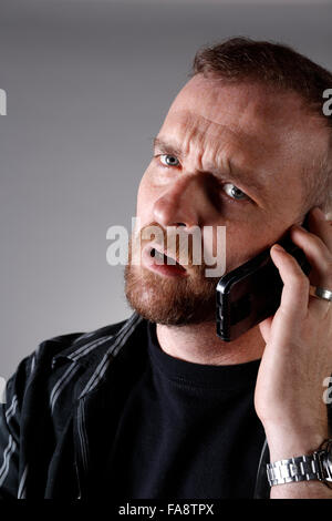Angry man talking on the phone Stock Photo - Alamy