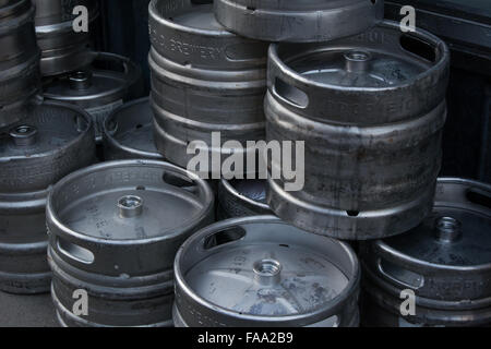 Different types of metal beer kegs being distributed and stored in ...