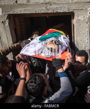 Palestinian mourners carry the body of 22-year-old Mahmud al-Atrash ...