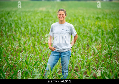 Corn farmer in field, portrait of agronomist woman looking at crops in ...