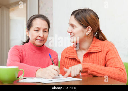 Two women fills in the questionnaire at home Stock Photo - Alamy